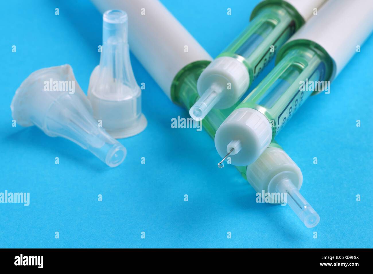 Insulin syringe pens and insulin needles with a drop of medicine at the ...