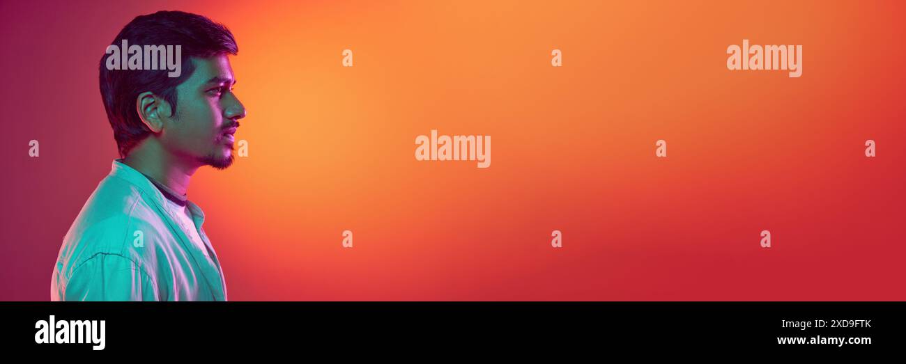 Banner. Side view portrait of young Indian man in looking at distance ...