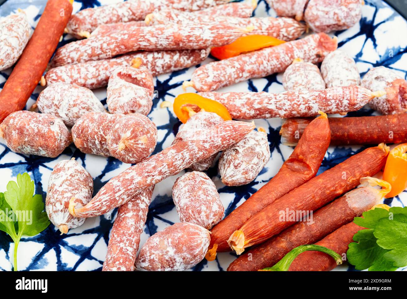 Spicy smoked salami on a plate. Smoked salami sticks Stock Photo - Alamy