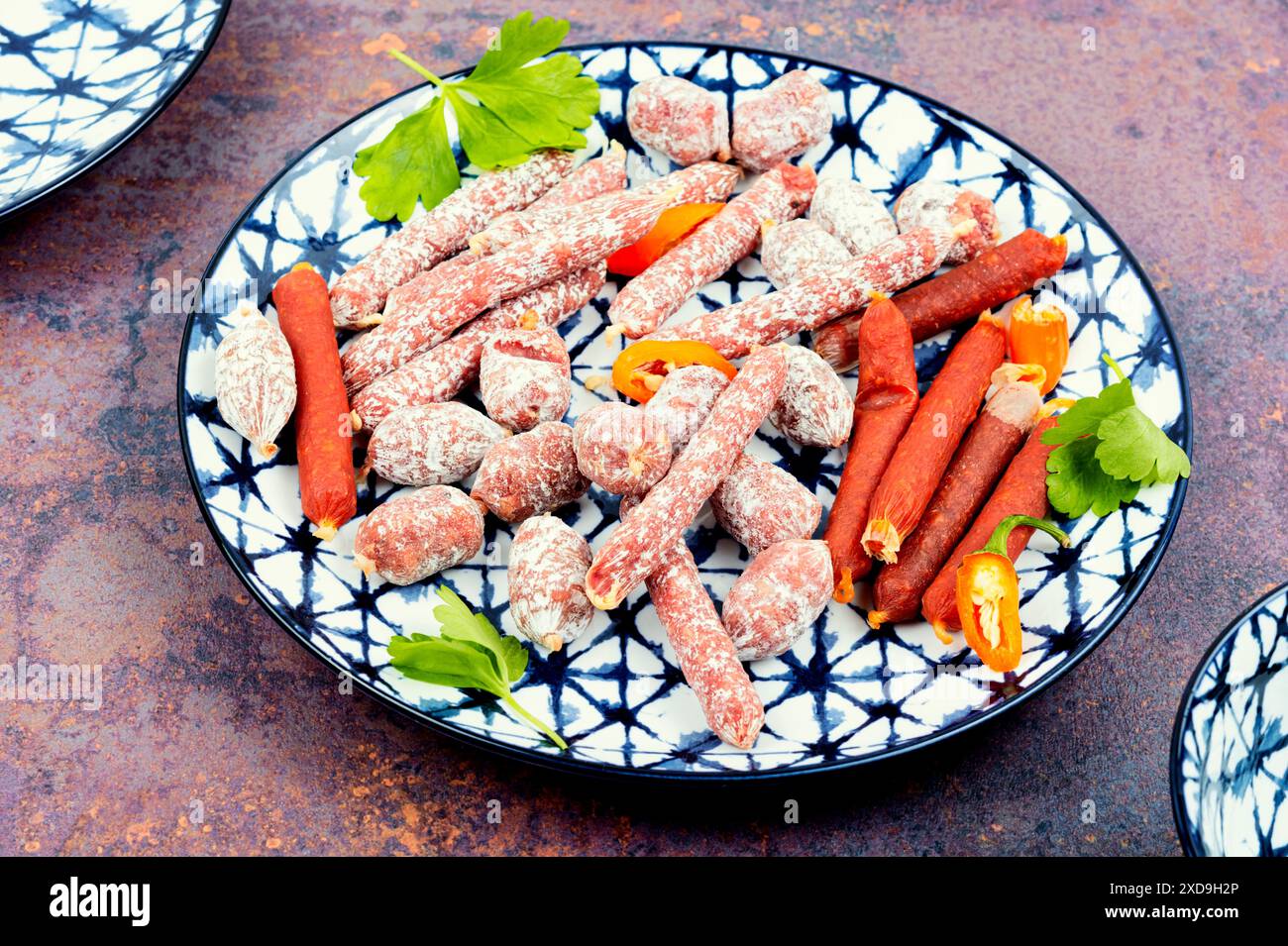 Set of different types of small sausage salami on a plate, meat ...