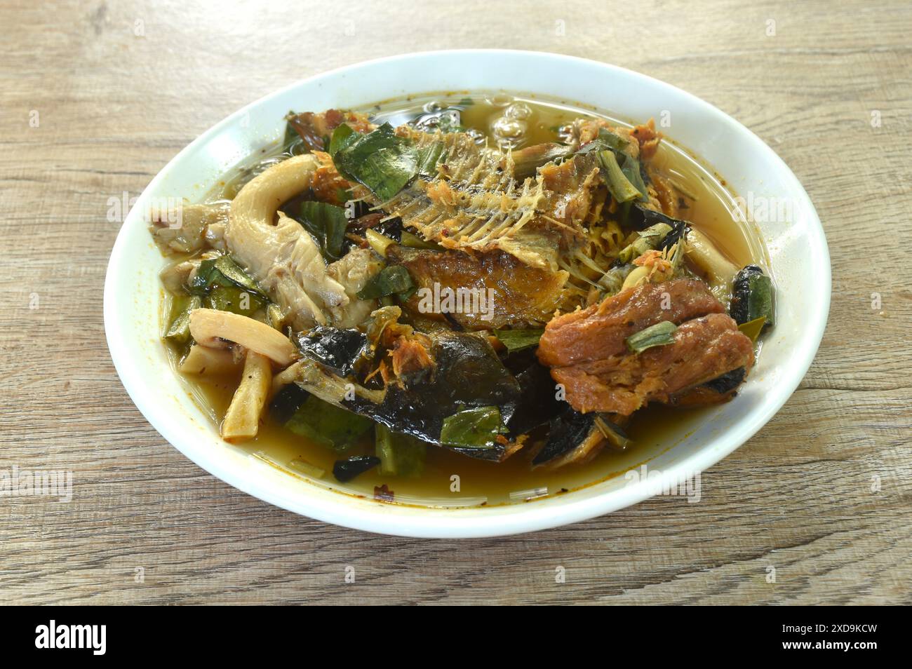 boiled smoked dry snake head fish in spicy and sour soup on plate Stock ...