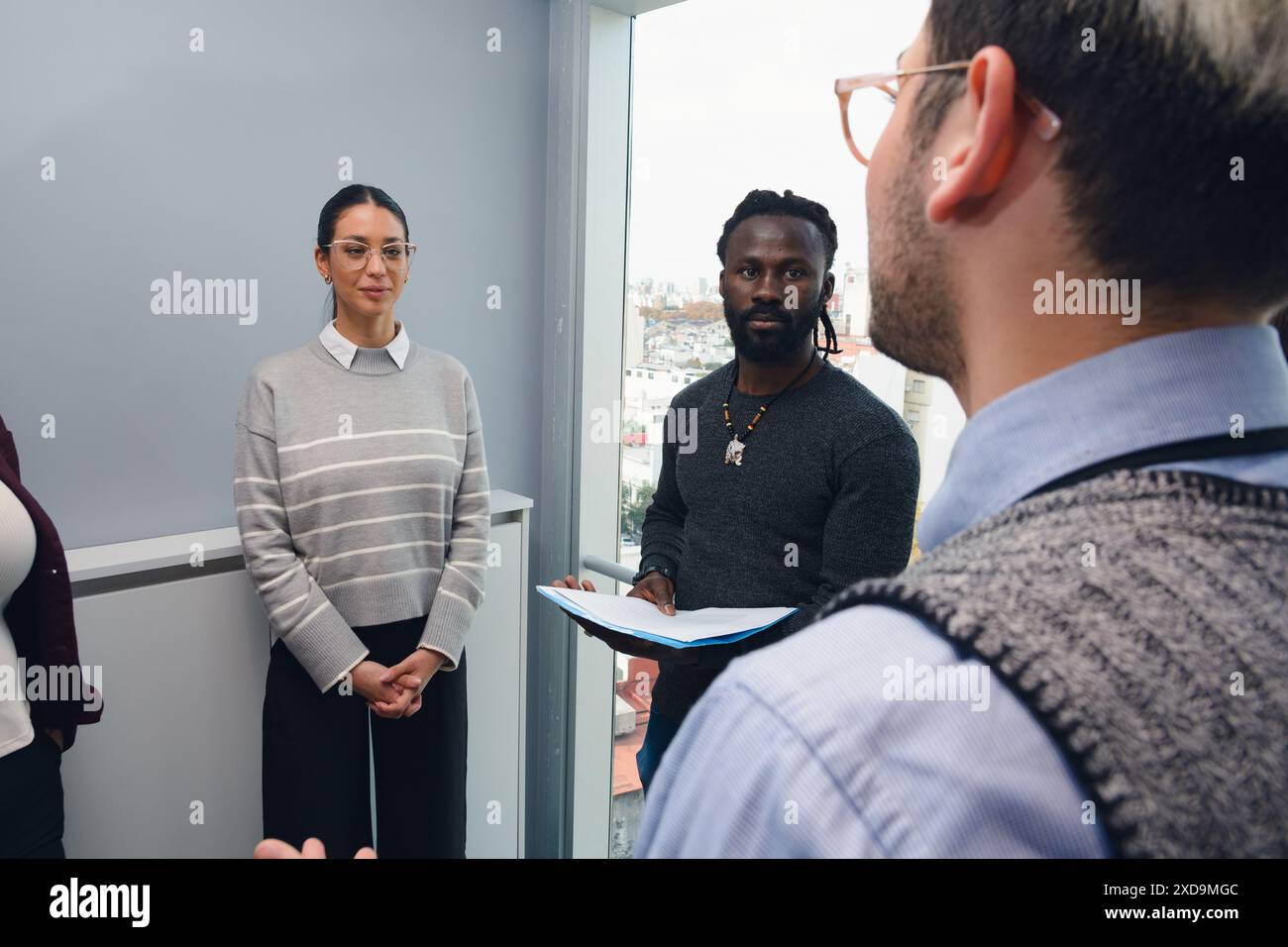 Employee Meeting in the office, are a young woman and a black man with ...