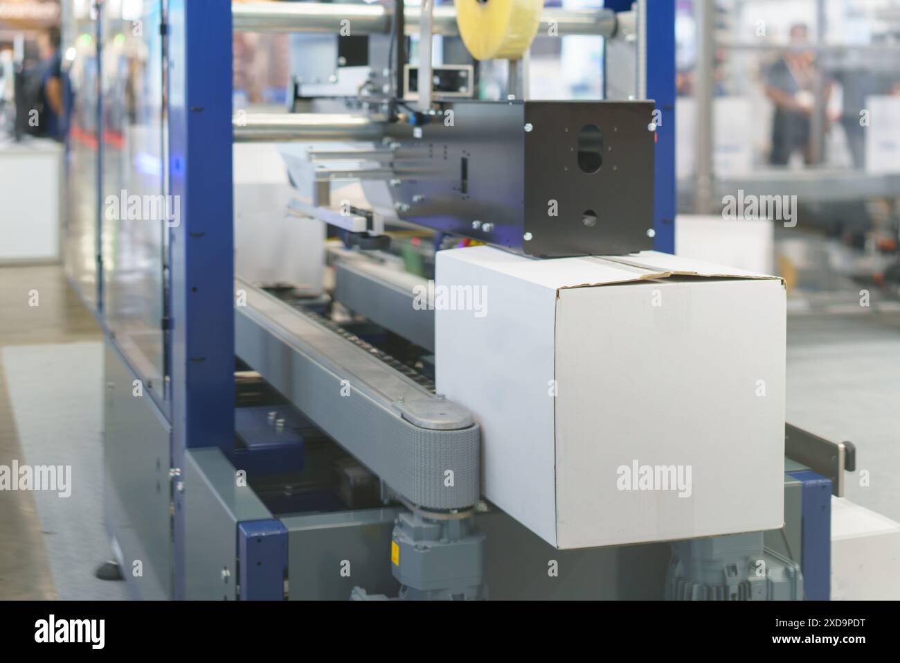 machine appears to use tape to close and seal cardboard boxes ...