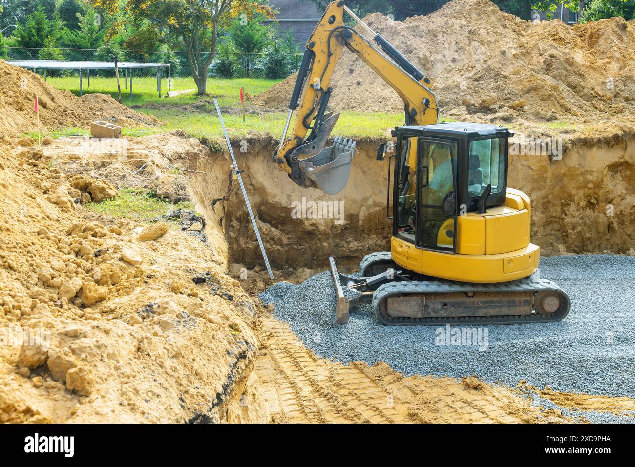 Excavators fill irregularities in excavations with granite rubble bases ...