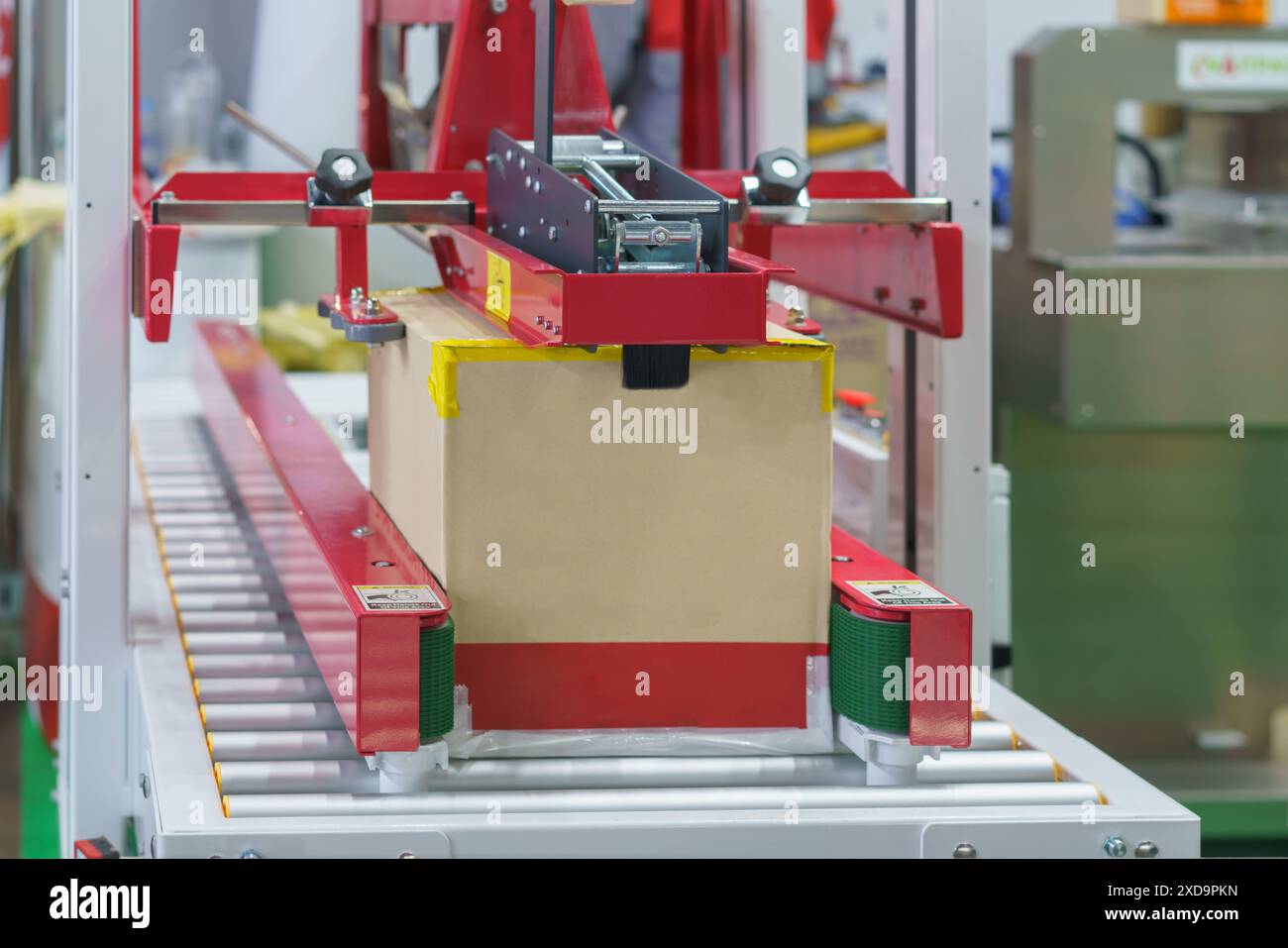 machine appears to use tape to close and seal cardboard boxes ...