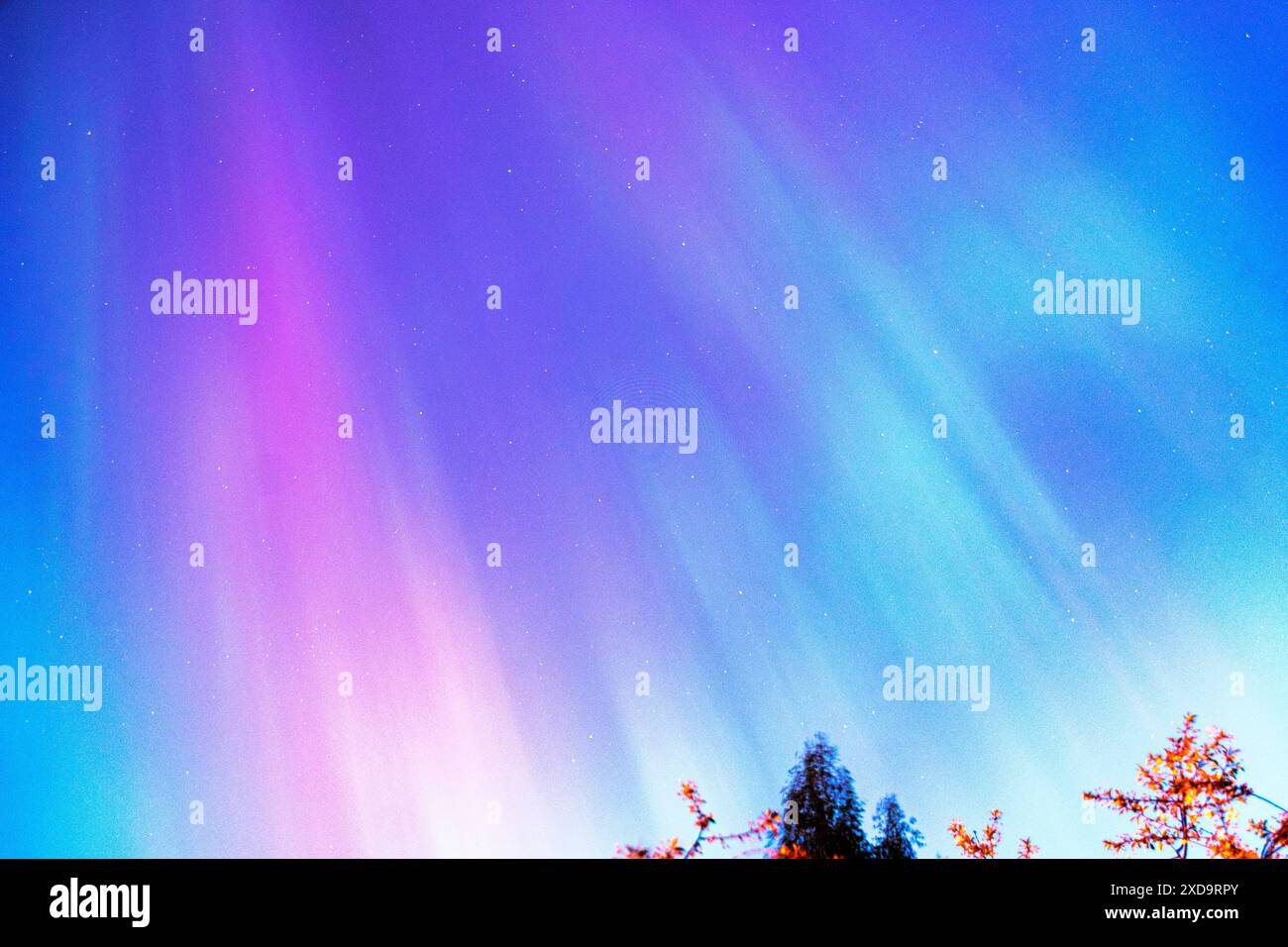 landscape with gorgeous northern lights over the roof of the house ...