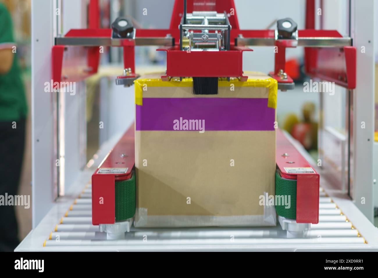 machine appears to use tape to close and seal cardboard boxes ...