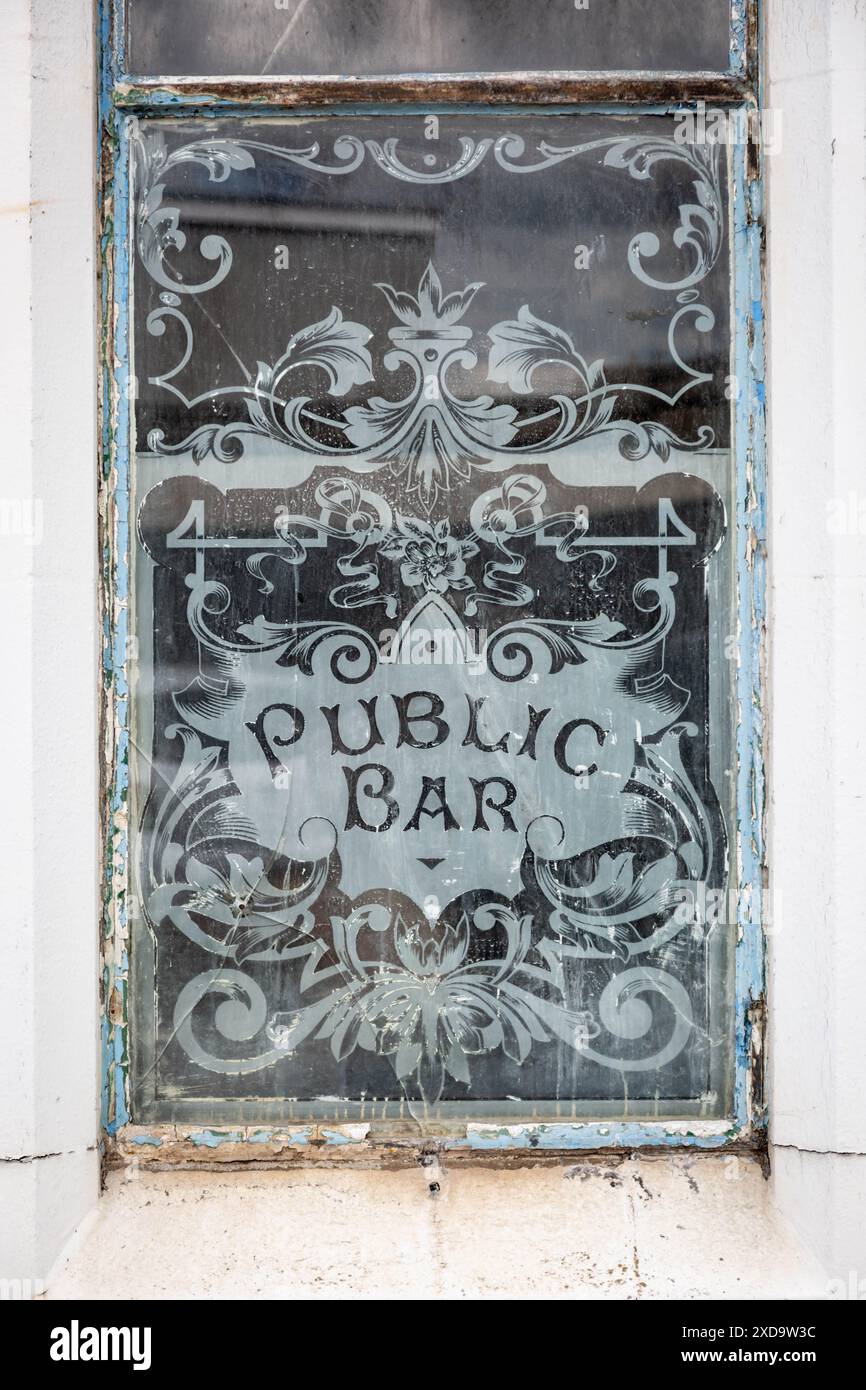 Old fashioned public bar window with etched or frosted glass writing ...