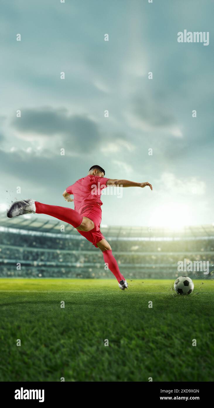 Vertical orientation. Soccer player winds up for powerful kick ...