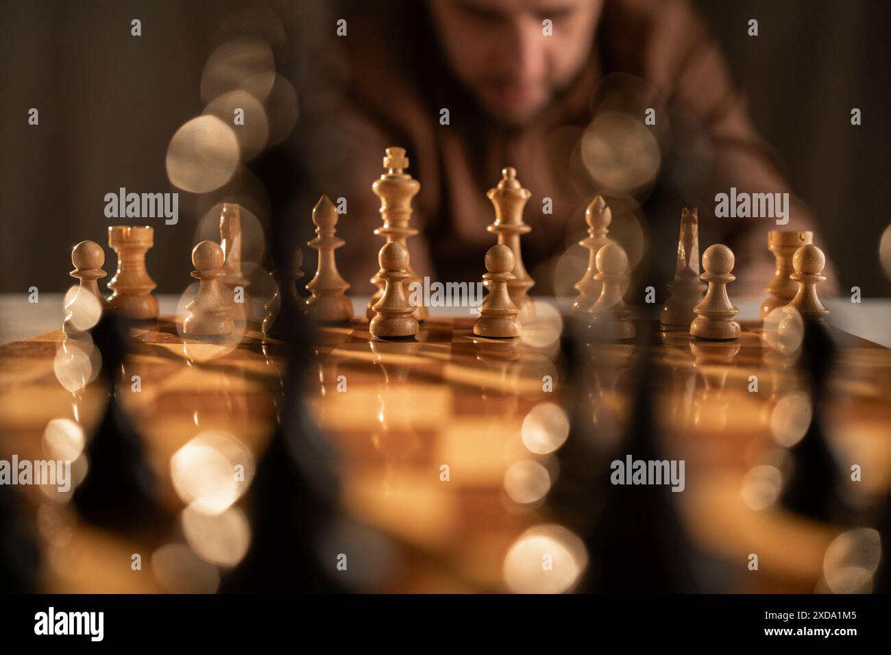 selective focus of chess board near man with mental syndrome on blurred ...