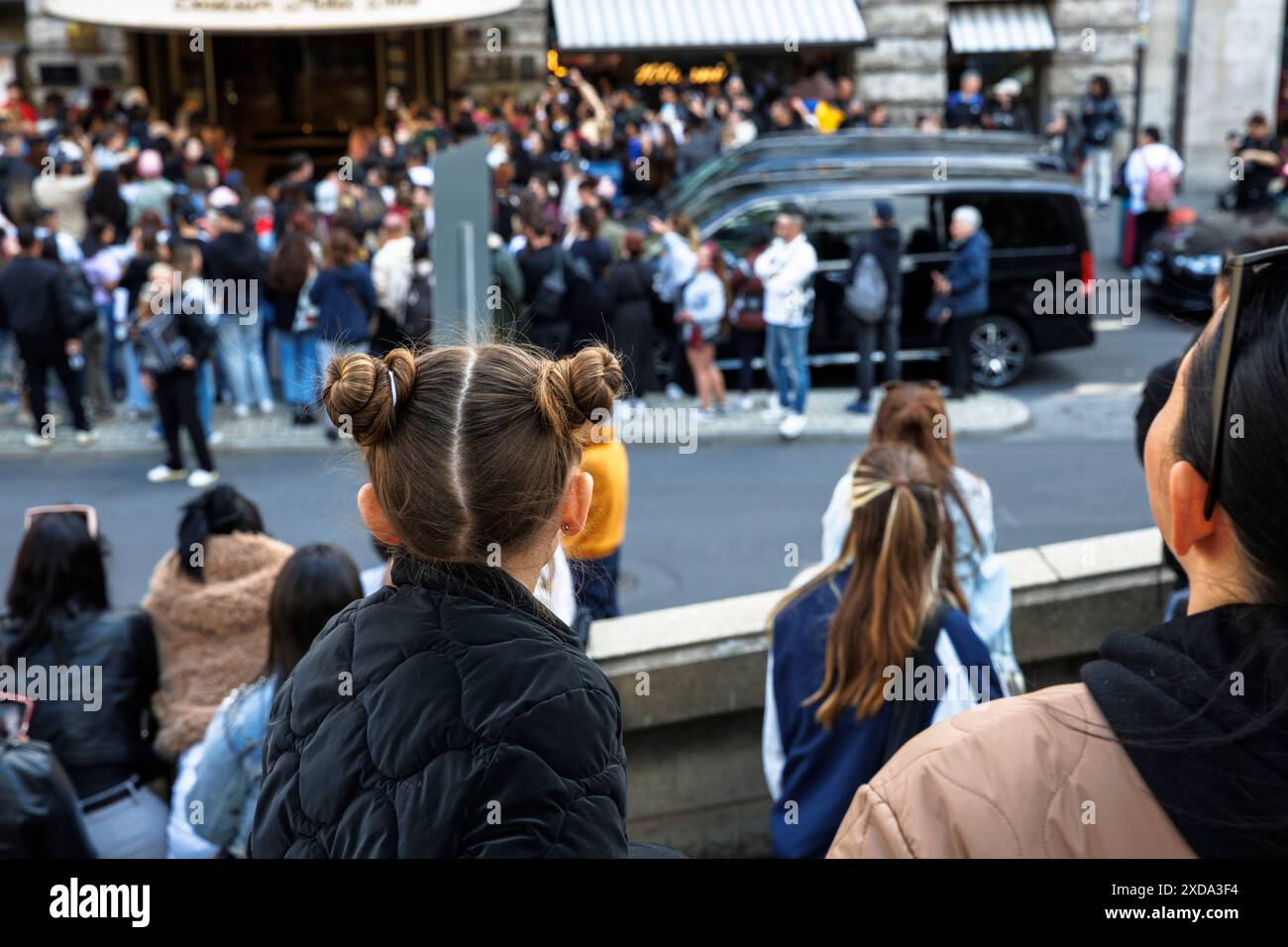 girl with plaits and many other fans of Colombian singer Karol G wait ...