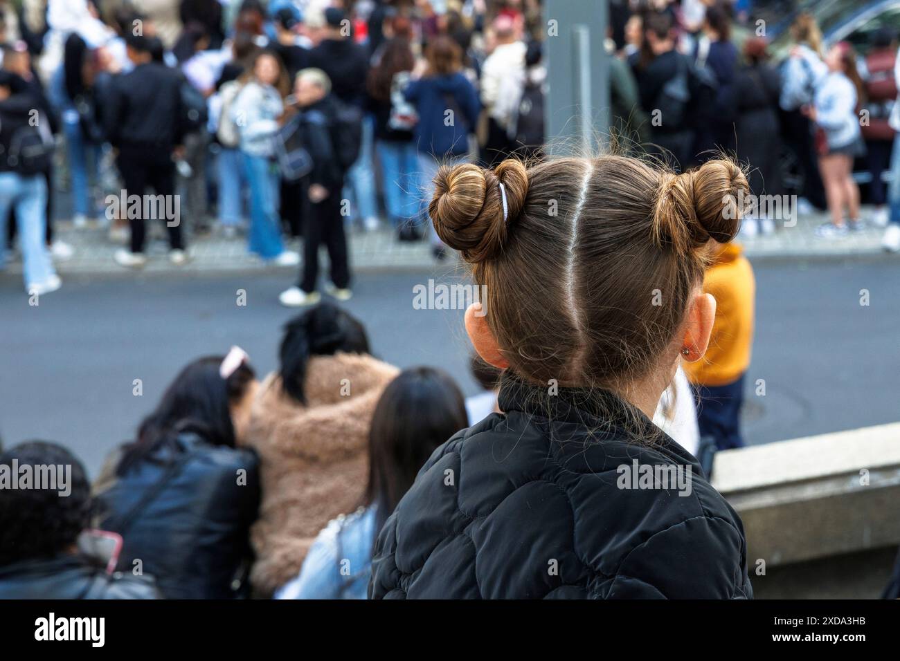 girl with plaits and many other fans of Colombian singer Karol G wait ...