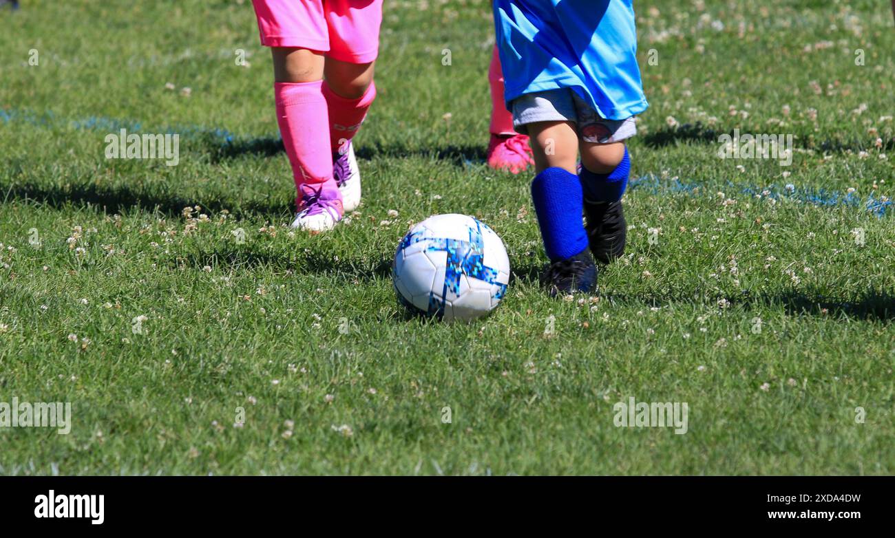 Child chasing ball hi-res stock photography and images - Alamy