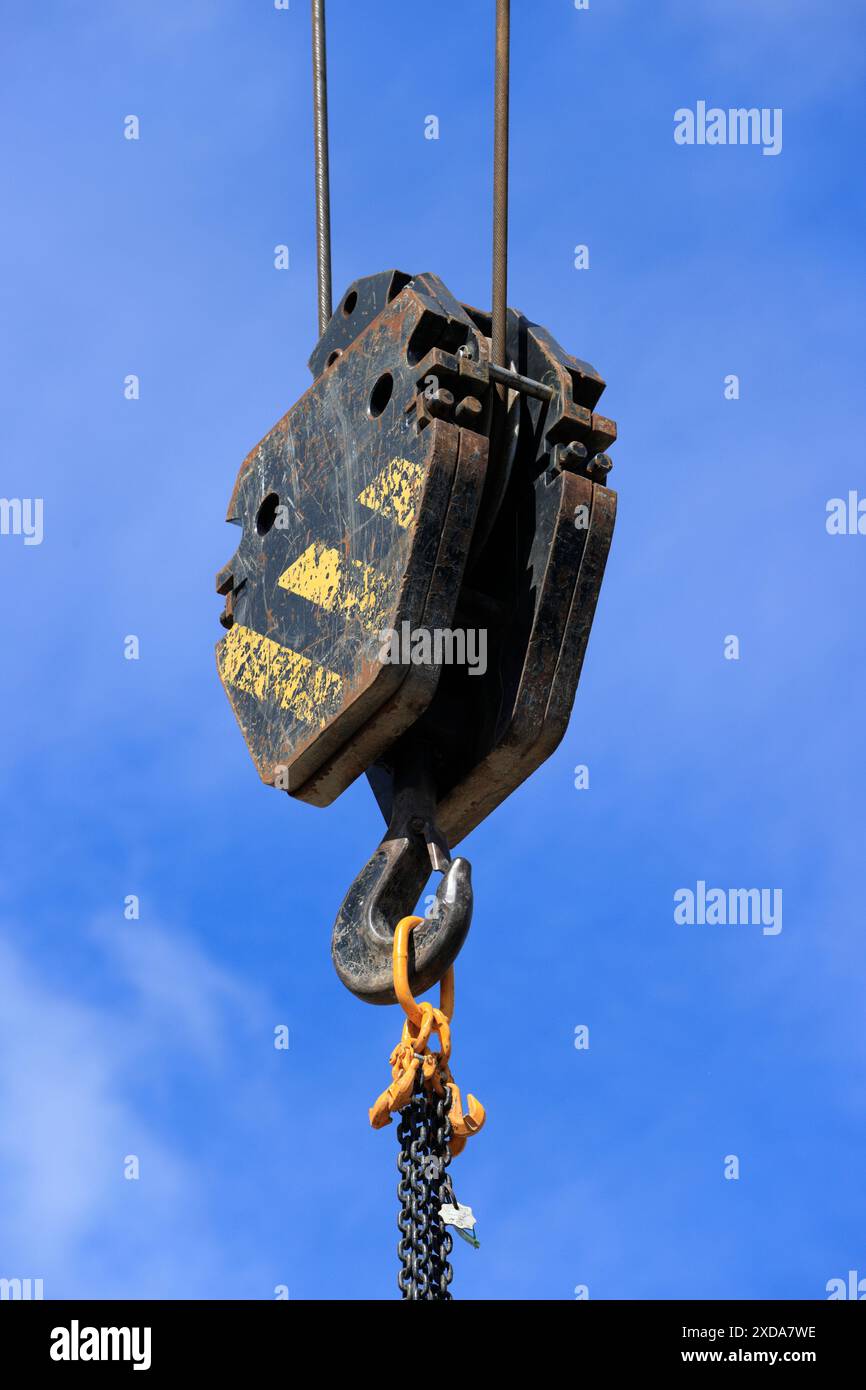 Mobile crane lifting block, wire ropes and chains with blue sky in ...