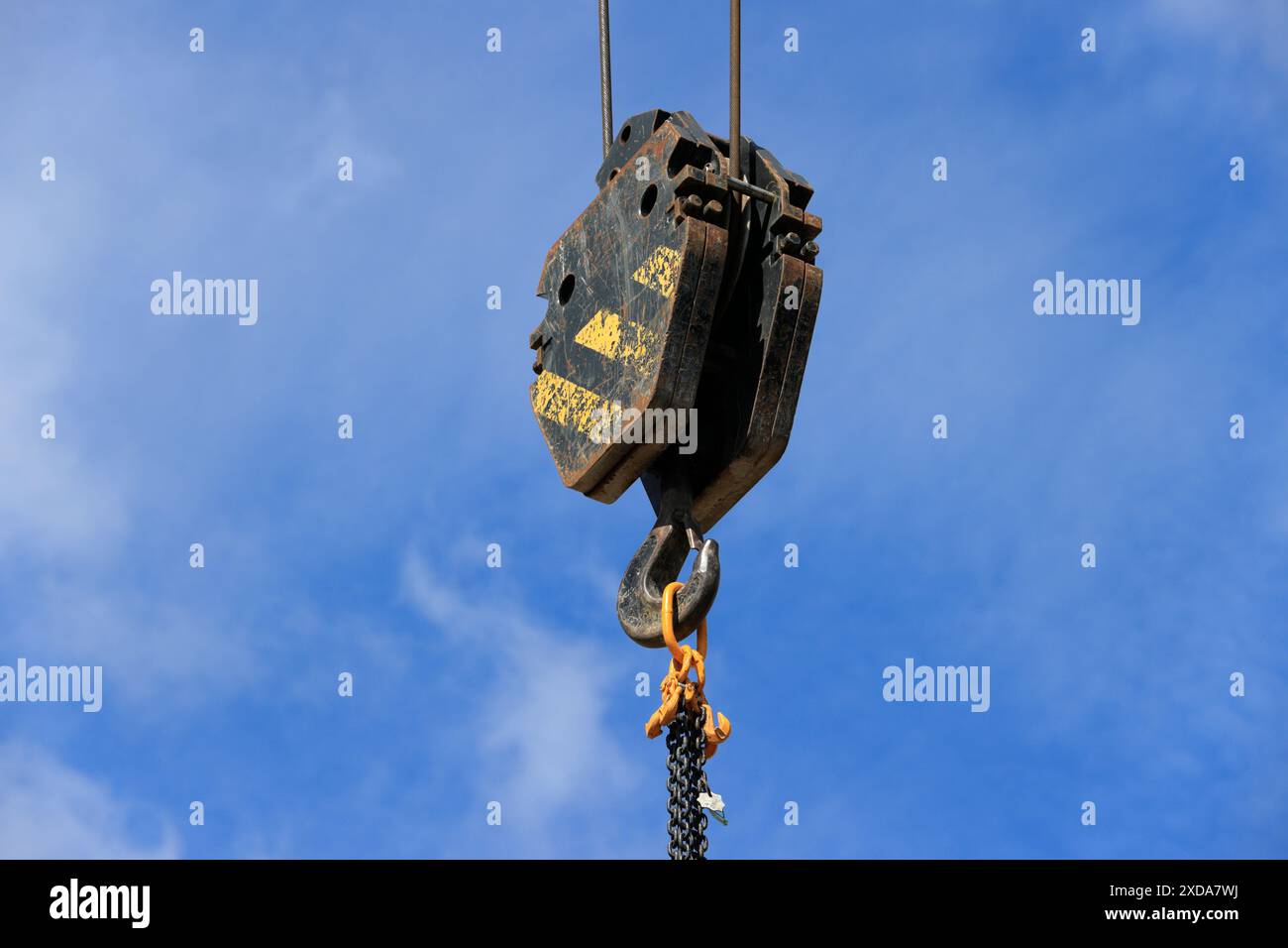 Mobile crane lifting block, wire ropes and chains with blue sky in ...
