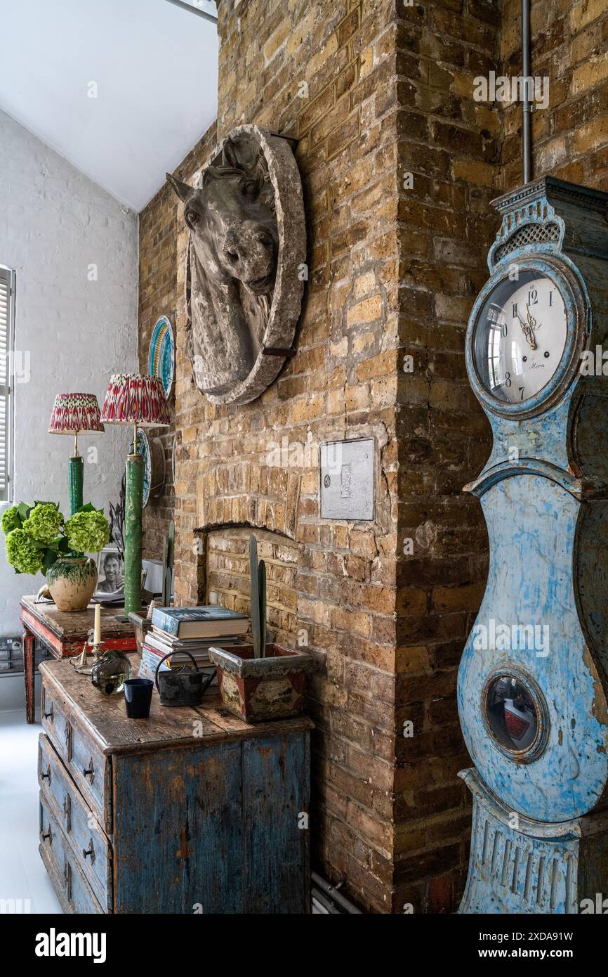 Plaster cast horse's head with Mora clock and exposed brickwork in late ...