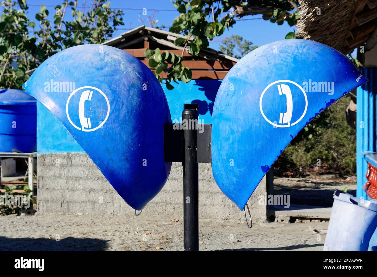 Cuba, Cuba, Central America, Two blue public telephones with a ...