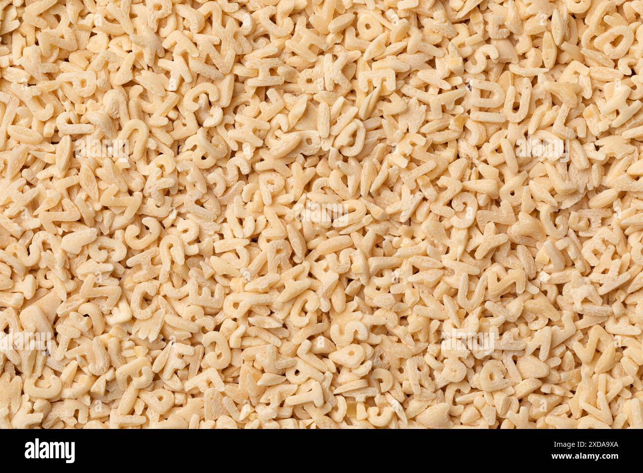 Heap of uncooked alphabets pasta isolated on white background close up ...