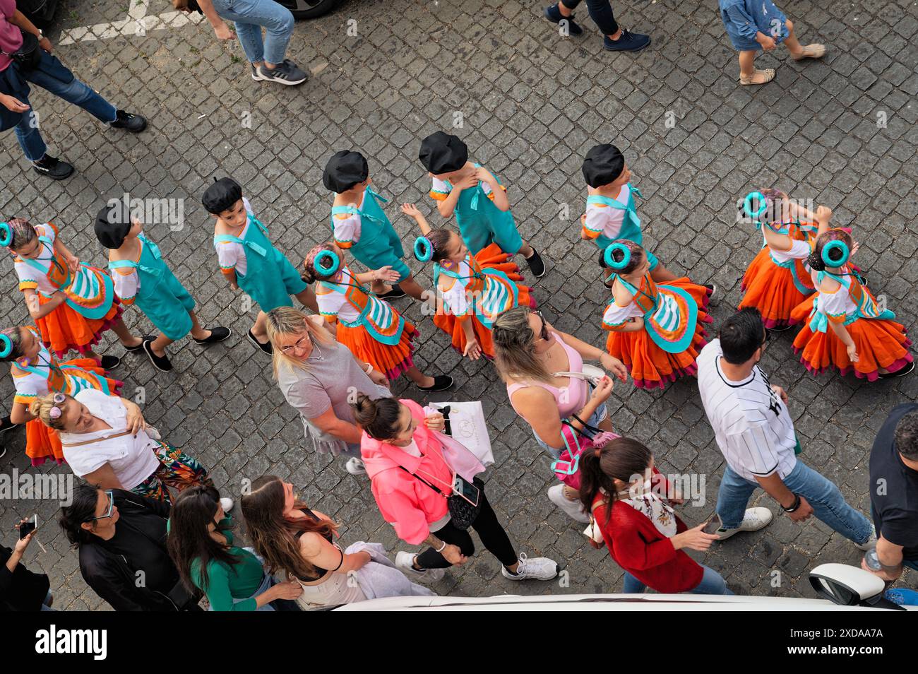 Children from a local school parading in colorful costumes on ...