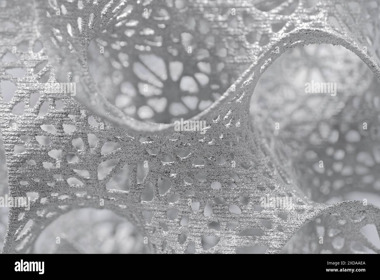 3D-printed white lacy grid, three-dimensional openwork lattice close up ...