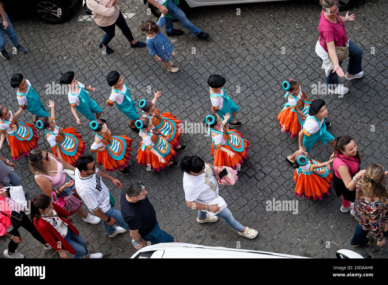 Children from a local school parading in colorful costumes on ...