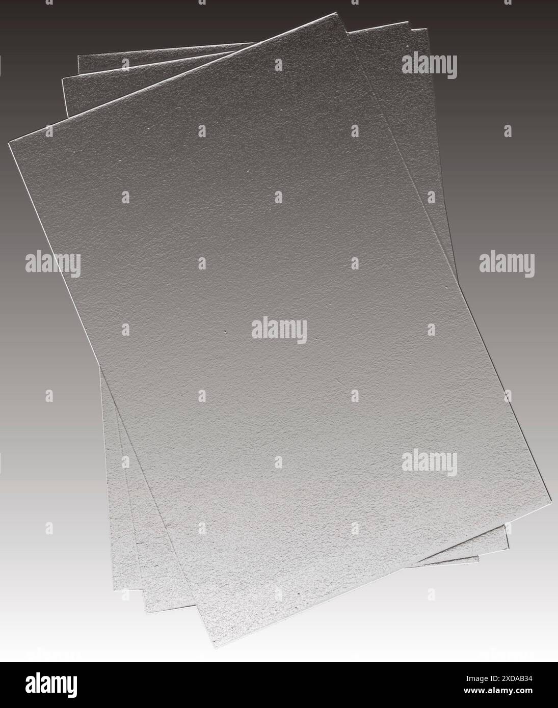 Stack of silver sheets arranged against a gradient background creating ...