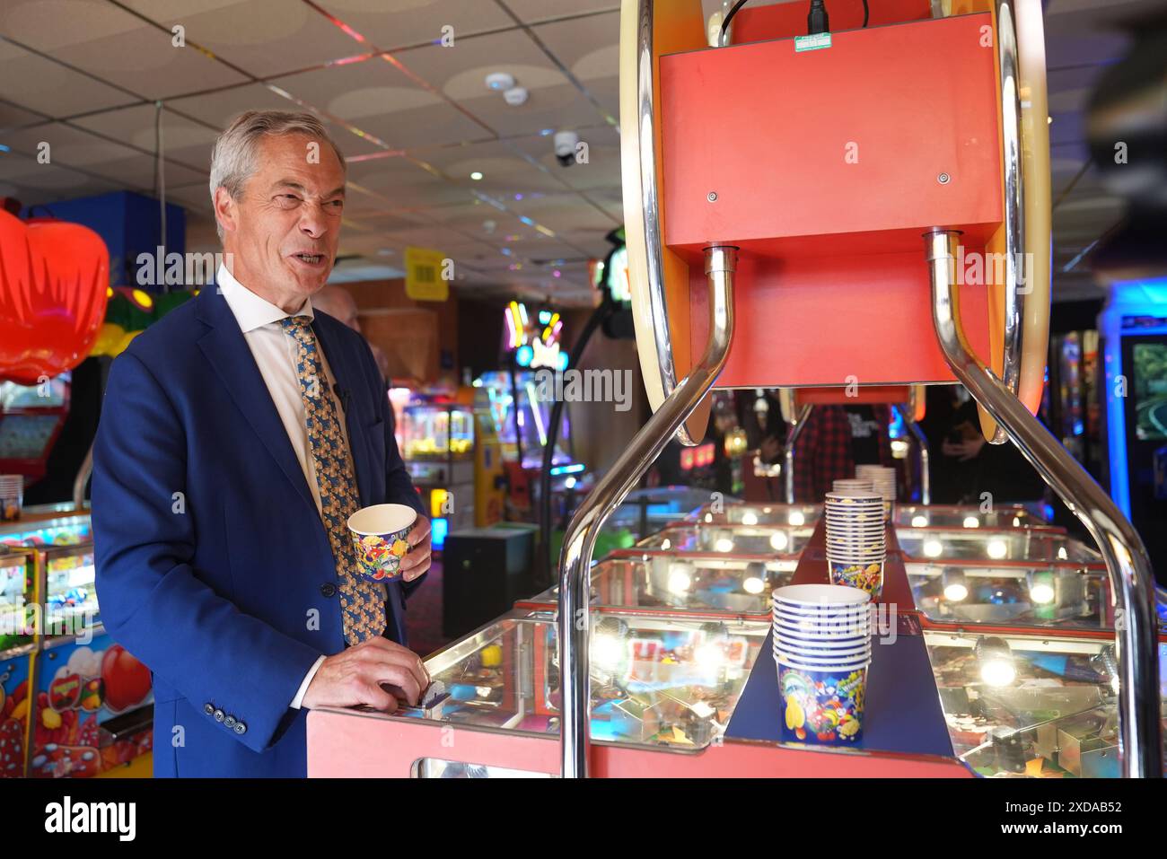Reform UK leader Nigel Farage playing a 2p machine in Clacton-on-Sea ...