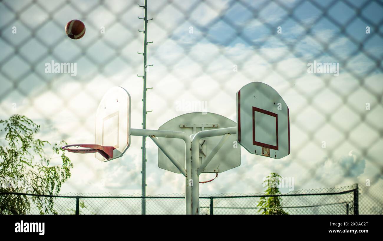 Outdoor basketball court with hoop and ball, ideal for backgrounds and ...