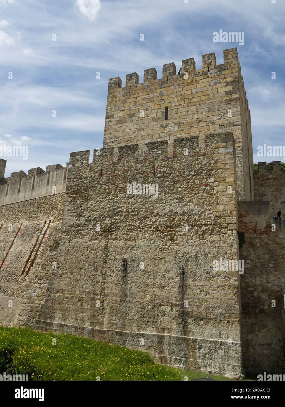 High castle building with stone tower and wall, blue sky in the ...