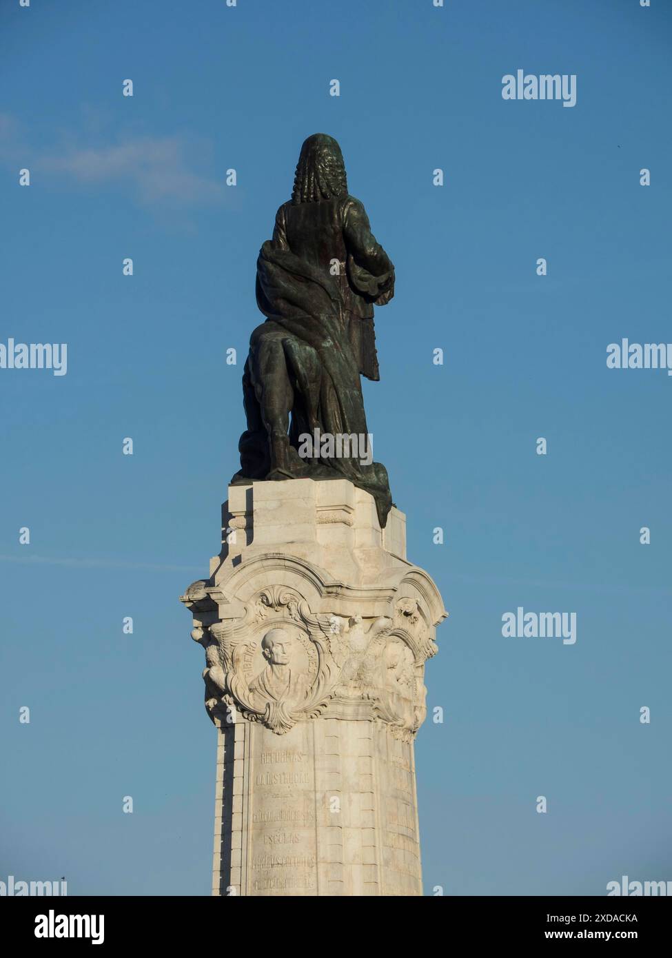 Historic statue of a figure standing on an ornate pedestal under a ...