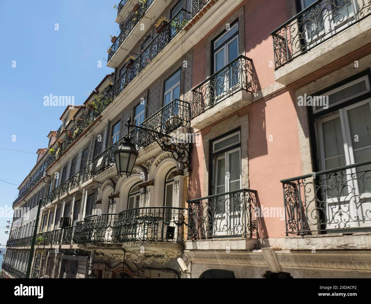 Old building facade with many windows and balconies, sunny day and ...