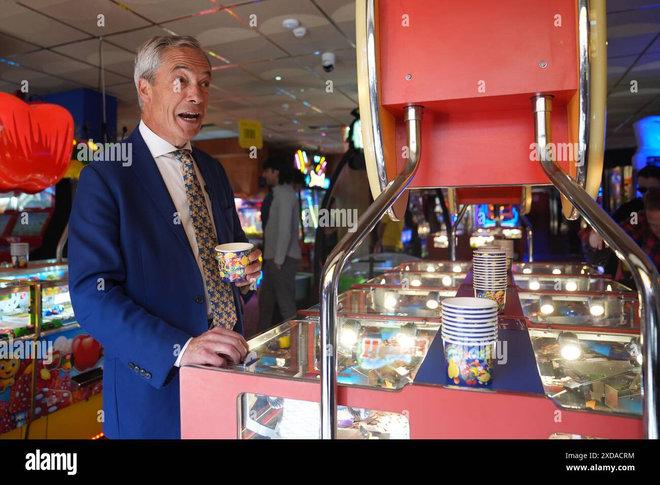 Reform UK leader Nigel Farage playing a 2p machine in Clacton-on-Sea ...