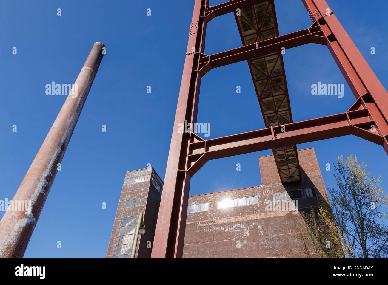 Industrial chimney and a large factory building with connected metal ...