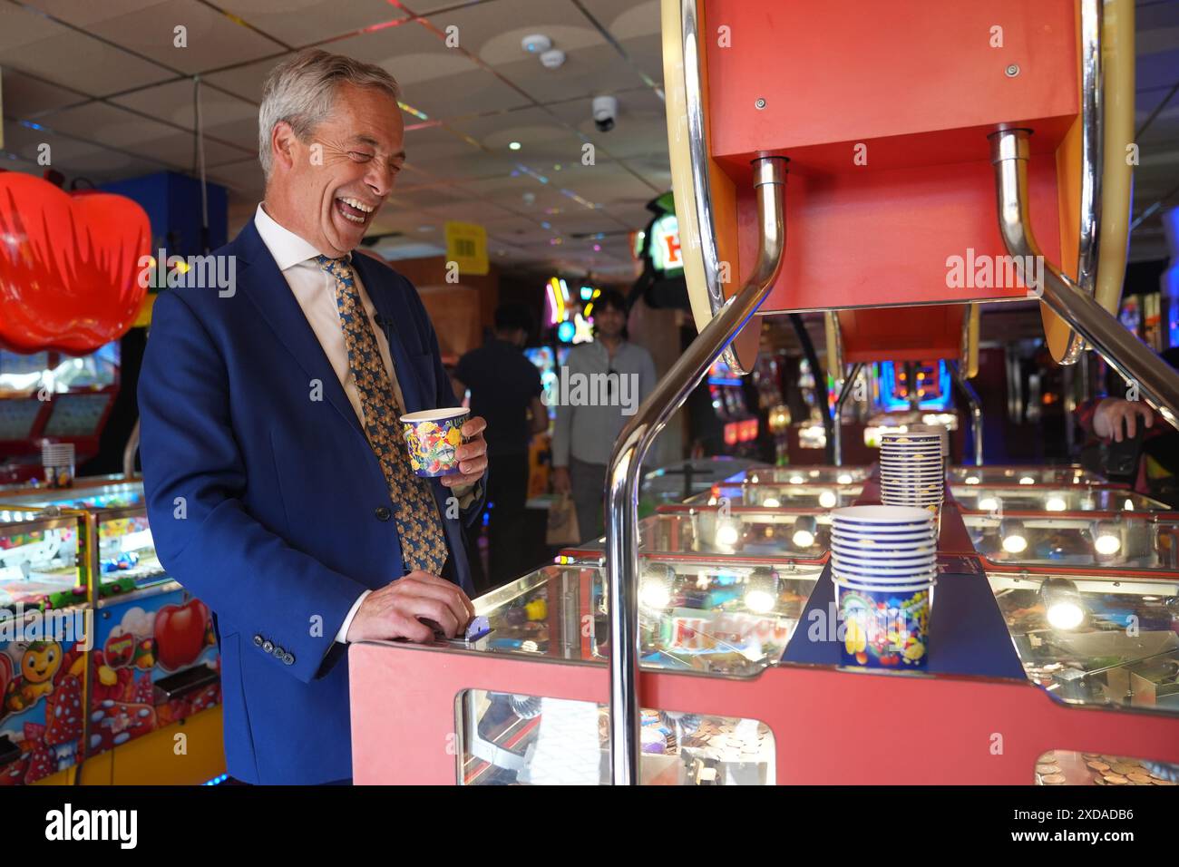 Reform UK leader Nigel Farage playing a 2p machine in Clacton-on-Sea ...