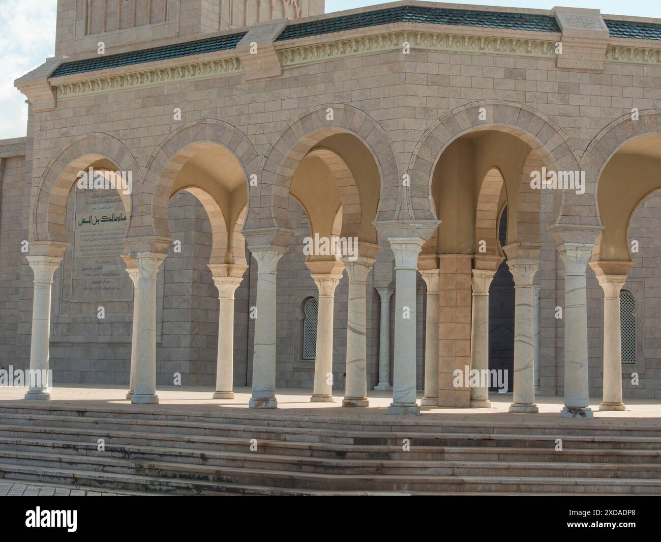 Historic sandstone arcades and columns with stairs in the background ...