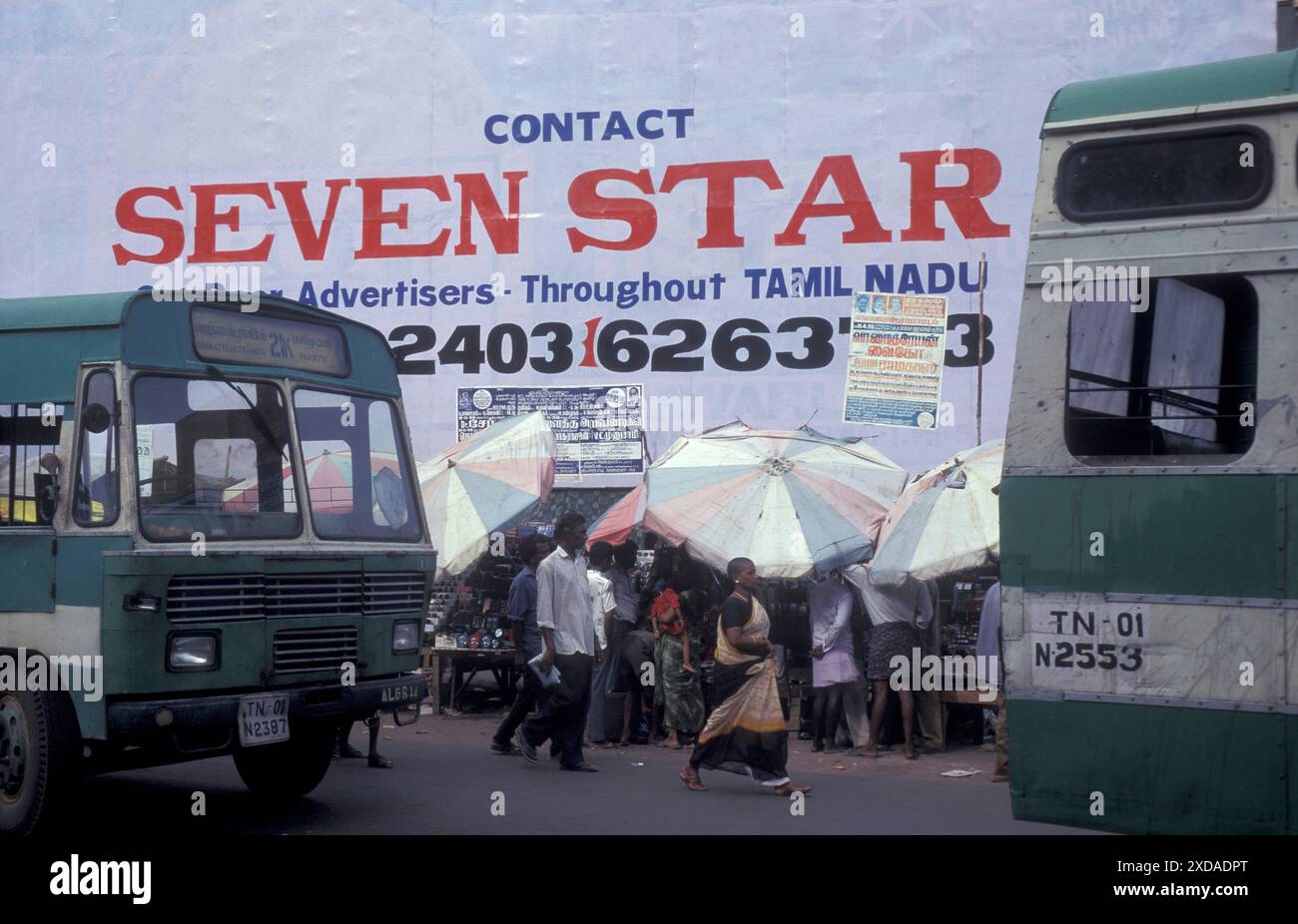 a public Bus Station in front of a advertising of Seven Star in the ...