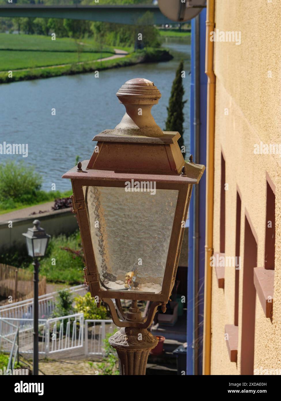 Close-up of an old street lamp standing along a path by the river ...