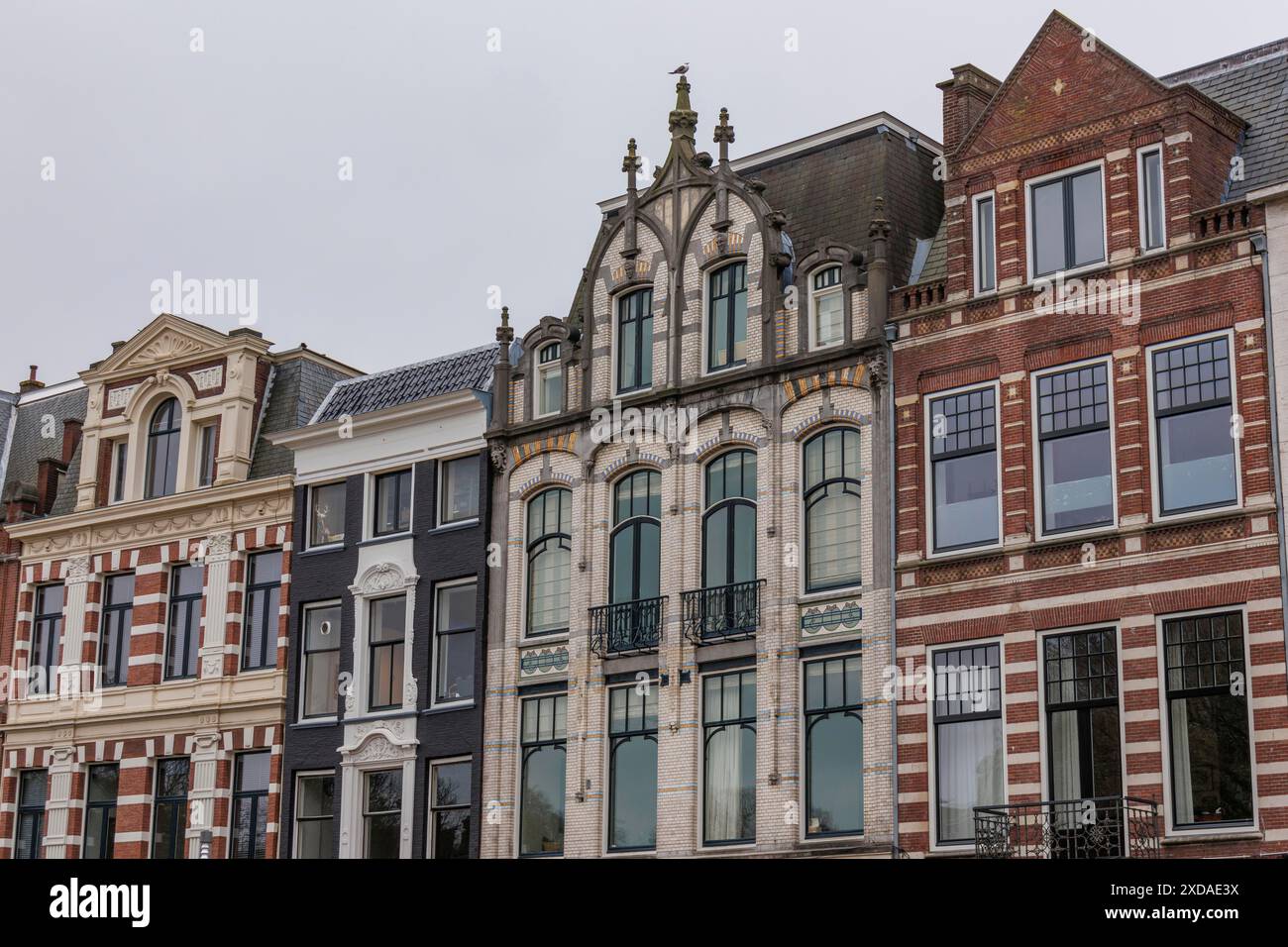 Row of historic townhouses with Victorian facades and large windows in ...