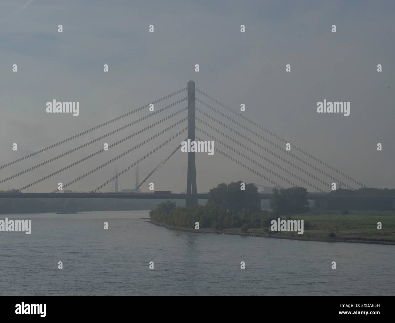 A modern bridge spans the river in a misty landscape, wesel, rhine ...