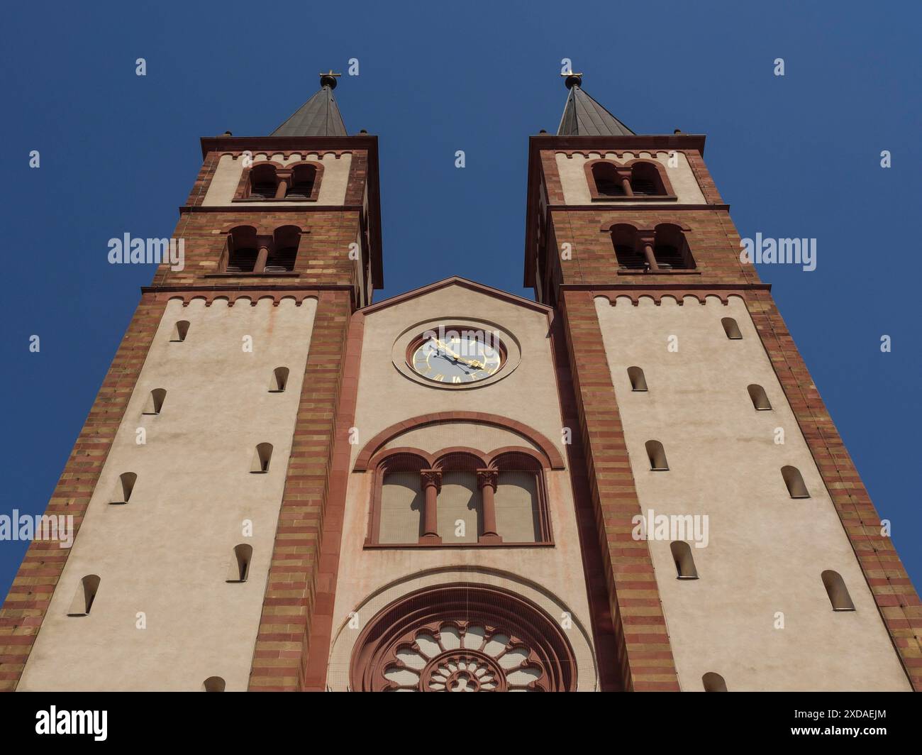 Front view of a Romanesque church with two towers and clock, wuerzburg ...