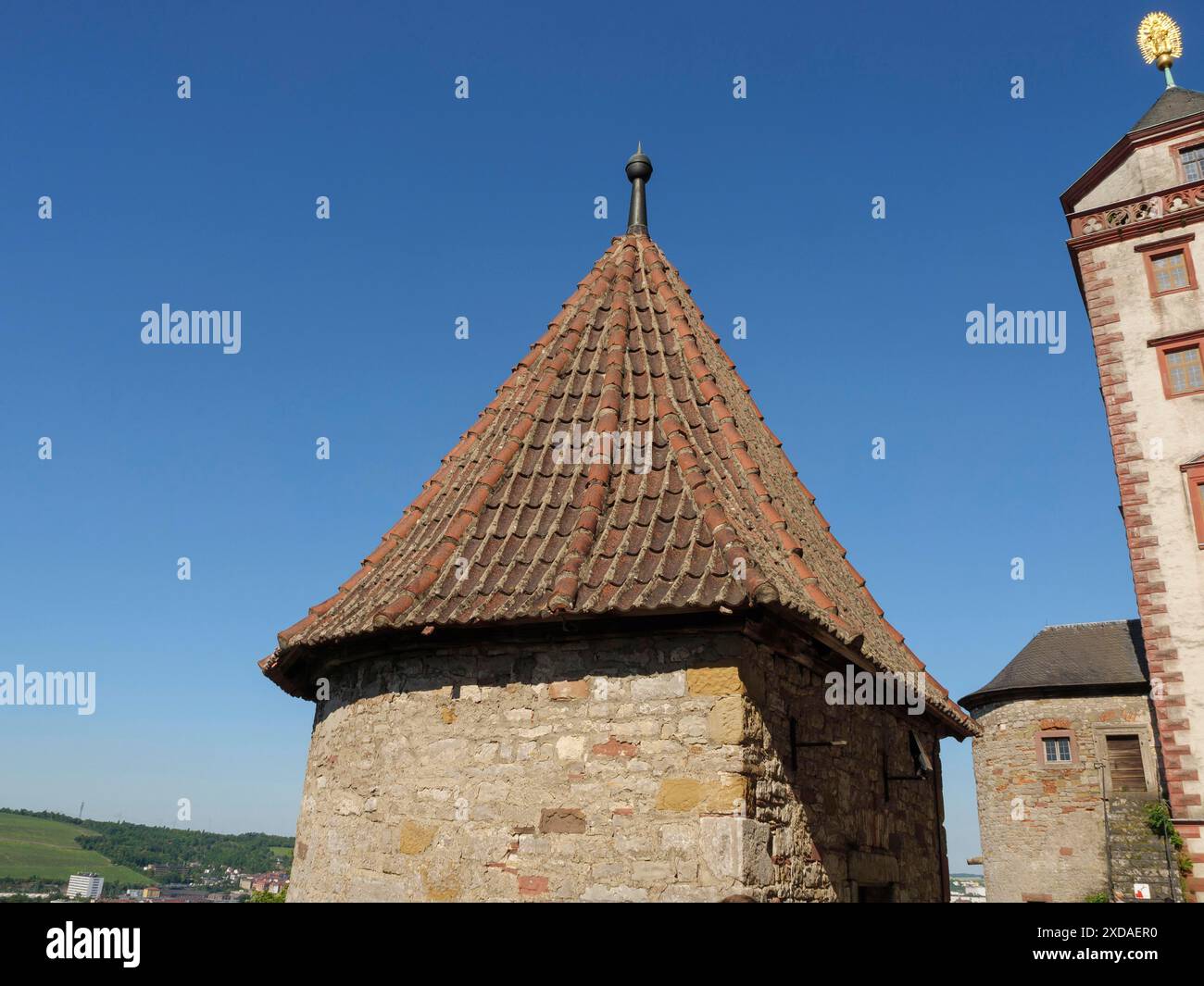Round castle tower with striking roof and historic stone architecture ...