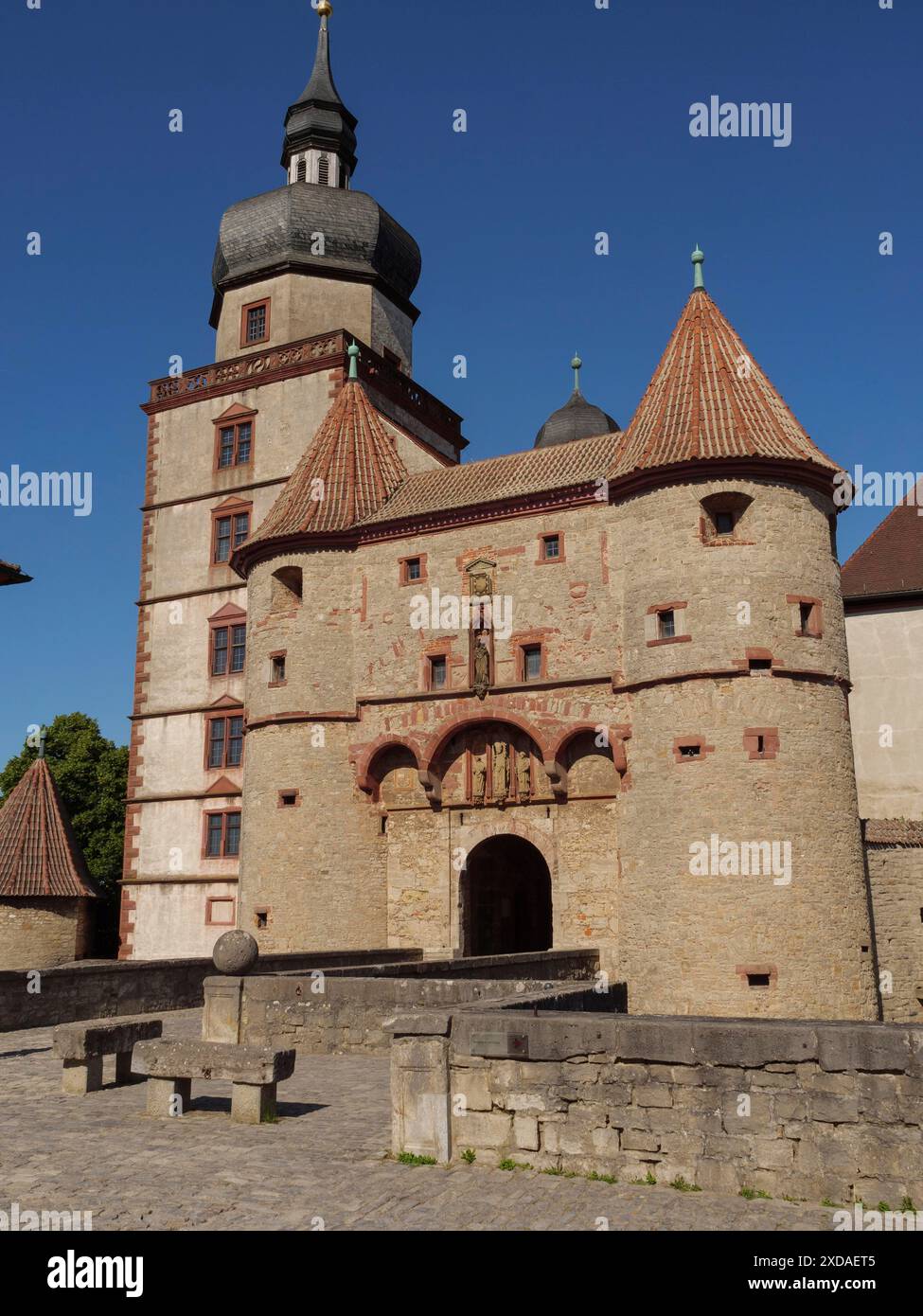 Impressive castle with high tower and large entrance gate, surrounded ...