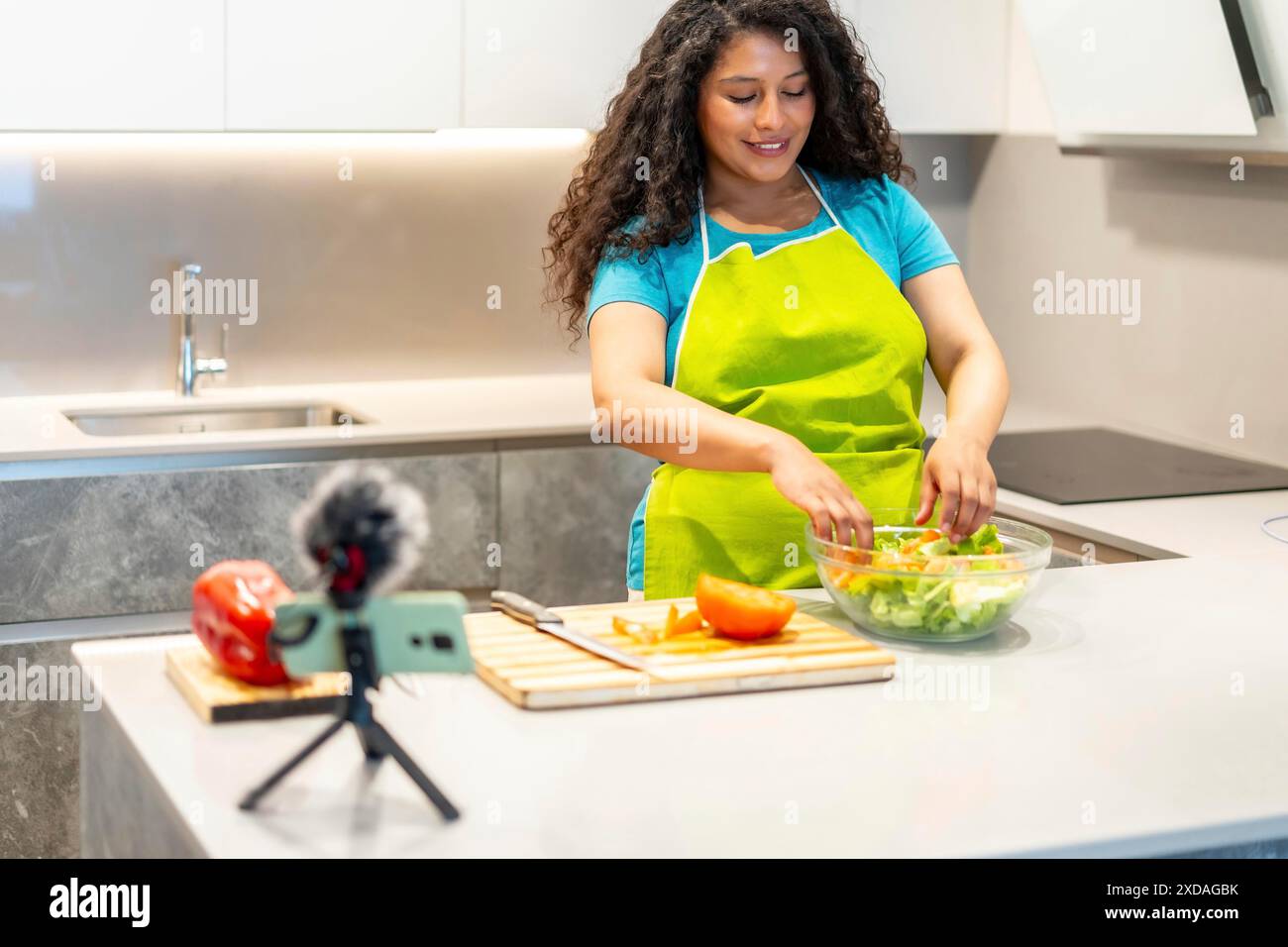 Female latin young clogger recording live streaming for cooking class ...