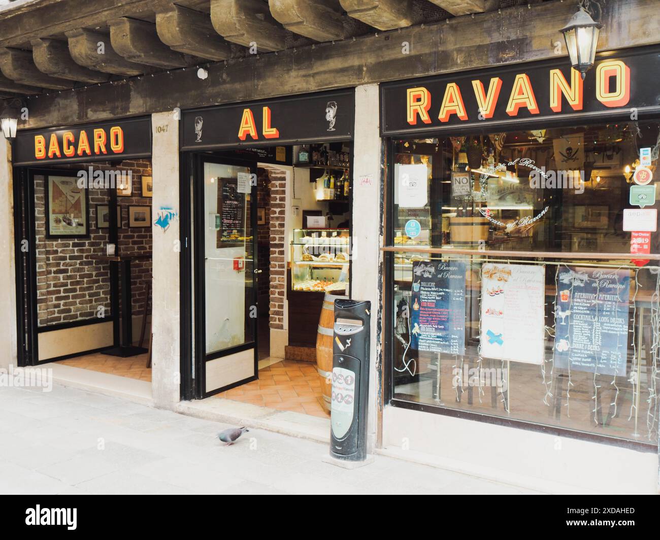 Entrance to a restaurant with bright signage and decorative lights ...