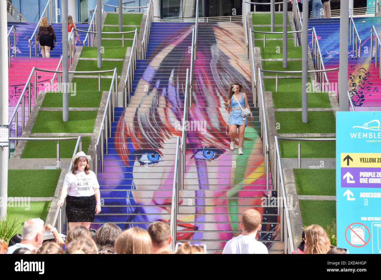 London, England, UK. 21st June, 2024. A woman walks down steps ...