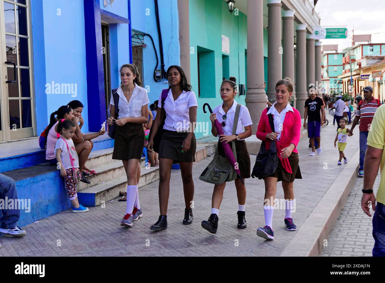 Baracoa, Cuba, Central America, Four girls in school uniform walk down ...