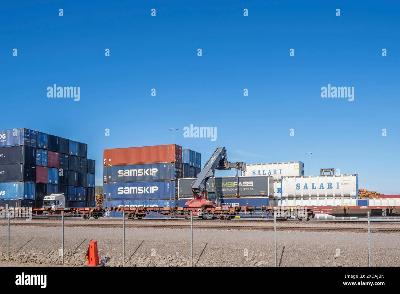 Loading of freight containers with a crane on railway wagon at an ...