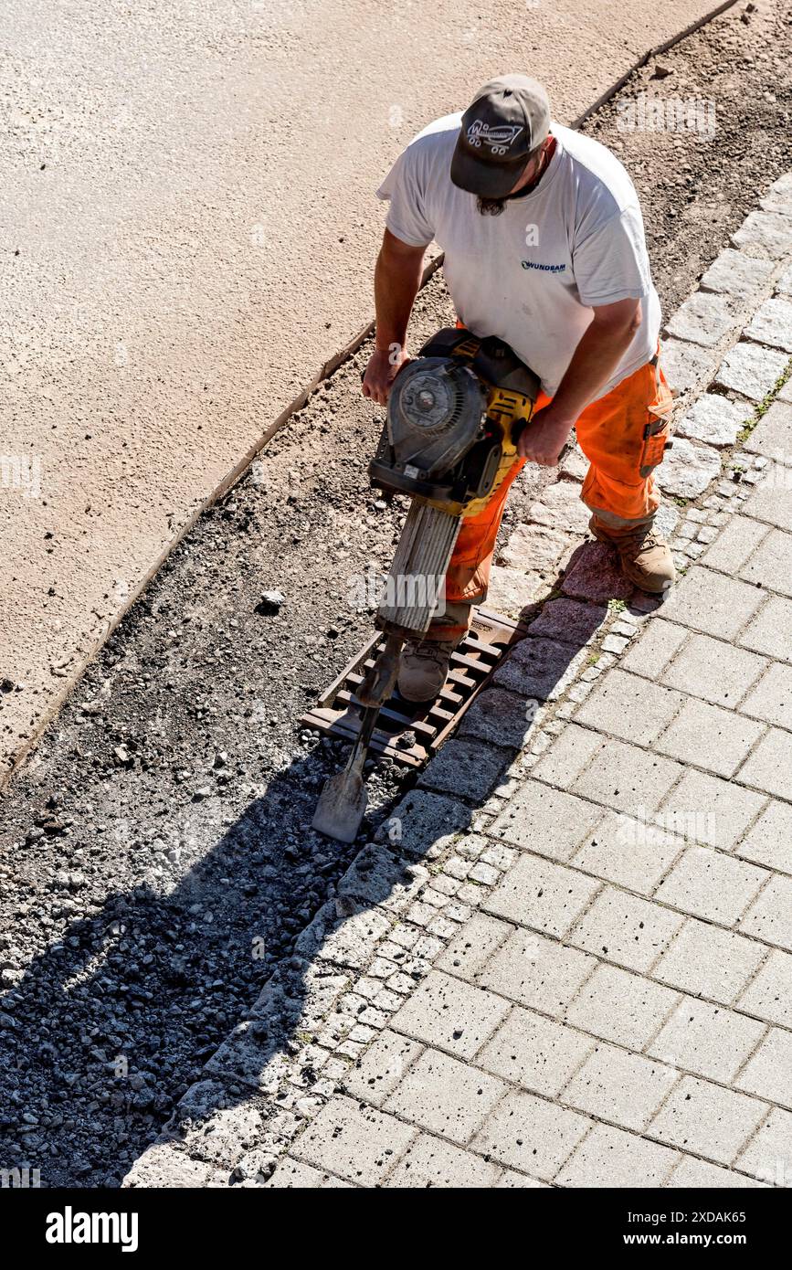 Construction worker with chipping hammer, chisel hammer, repair of road ...