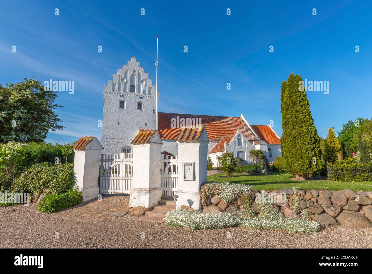 Whitewashed church in Dalby, side view, red roof, cemetery, stepped ...