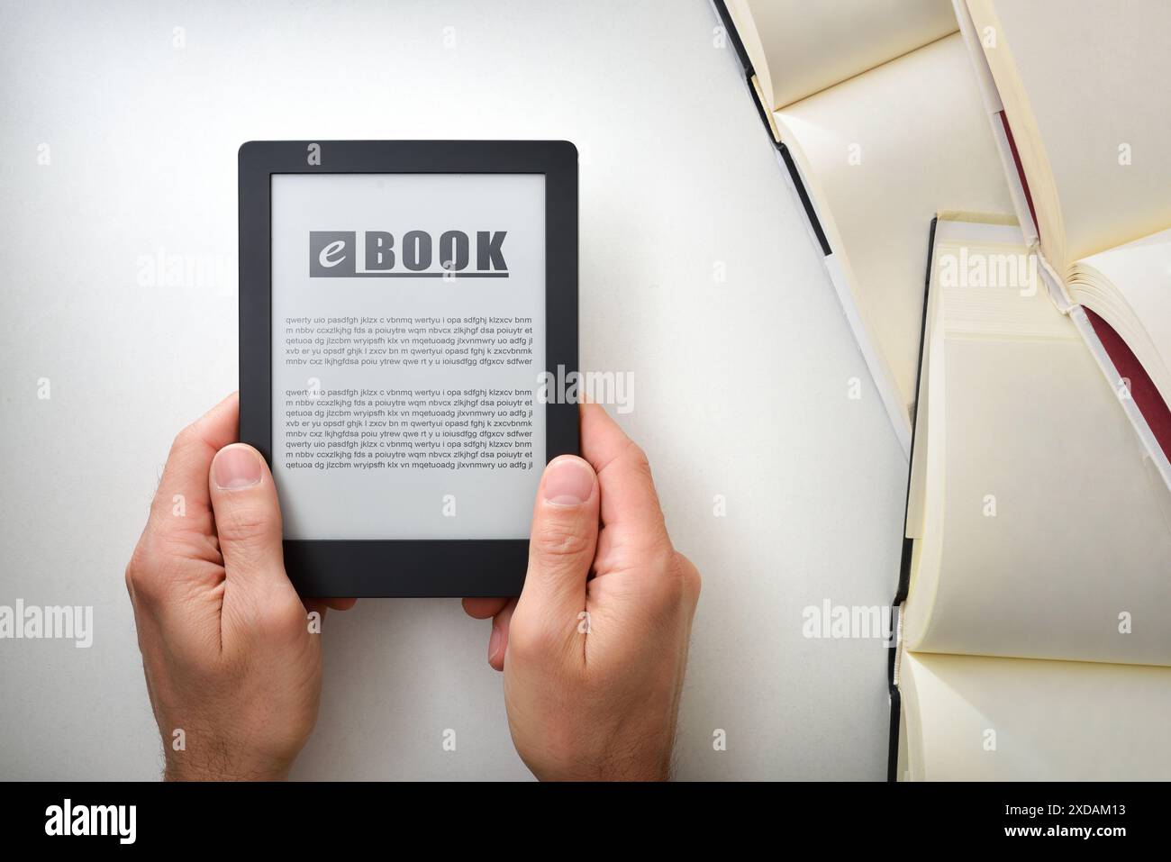 Detail of hands taking an ebook with text written on screen isolated on ...